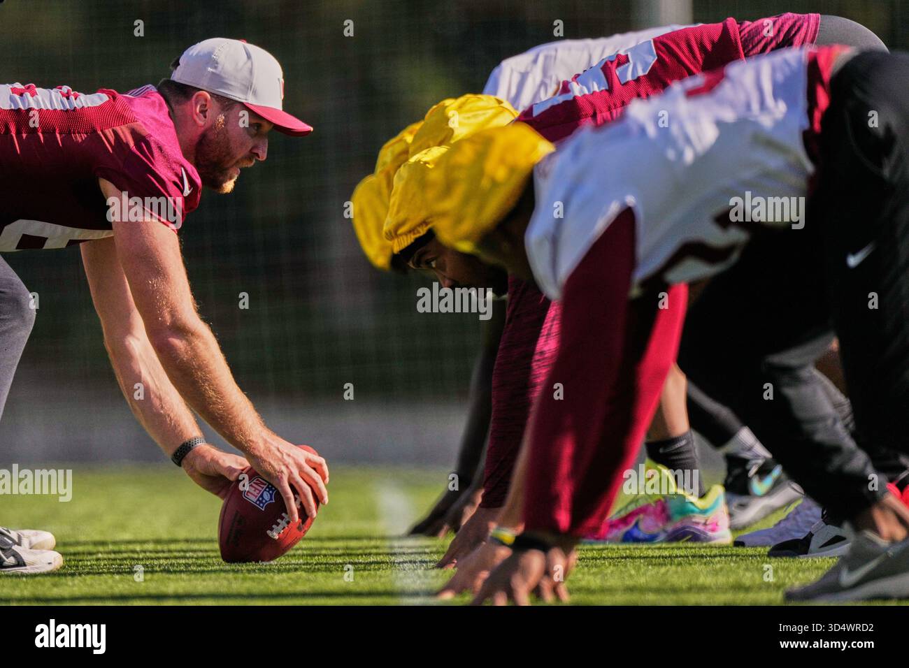 Washington Commanders players warm up during a training session in ...