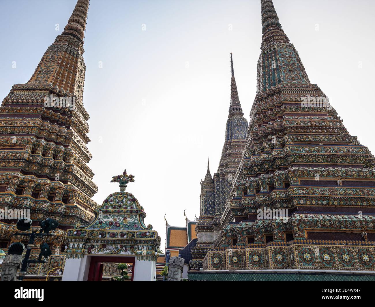 Ornate chedis reach skyward at Wat Pho in Bangkok, Thailand, showcasing ...