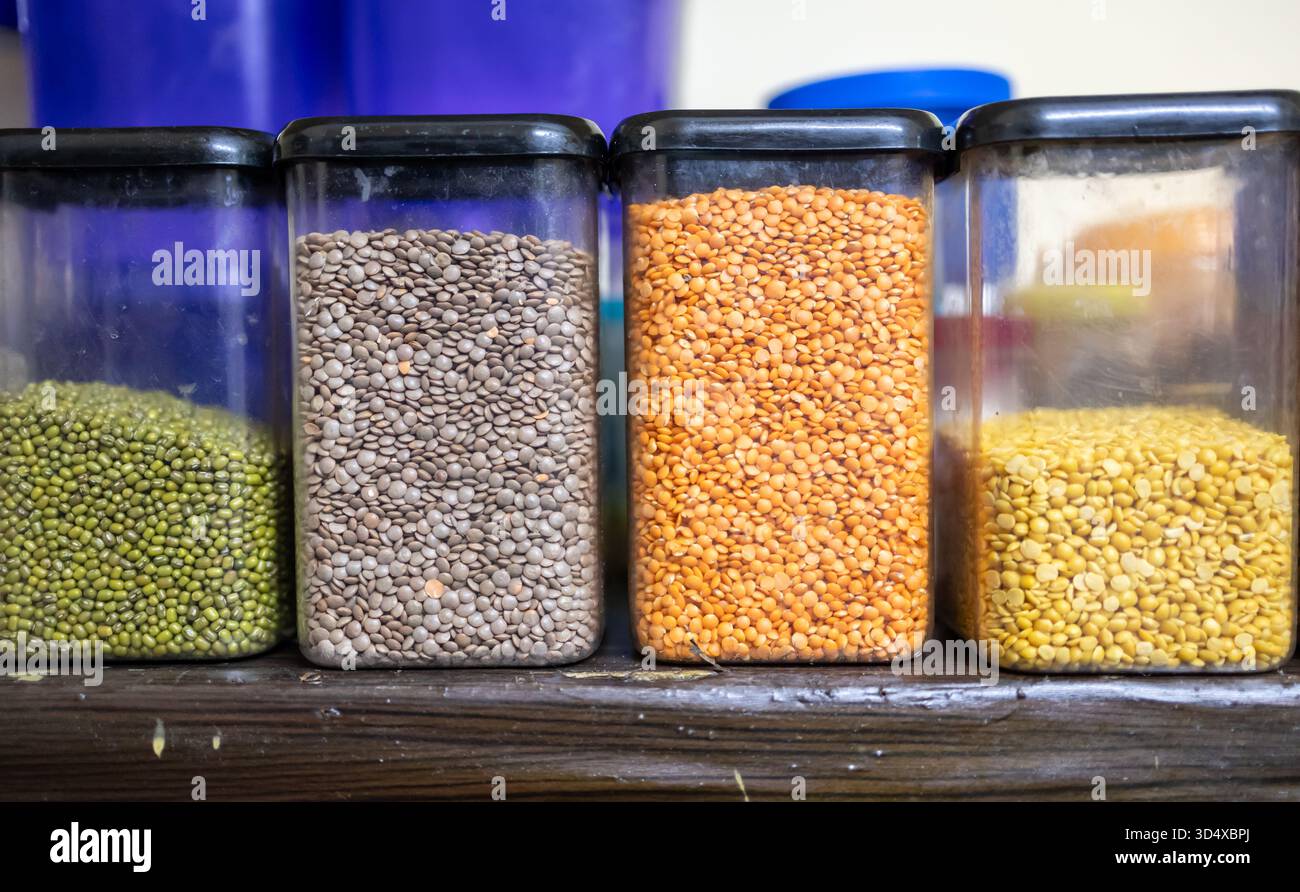 assorted indian lentils and pulses stored in transparent plastic ...