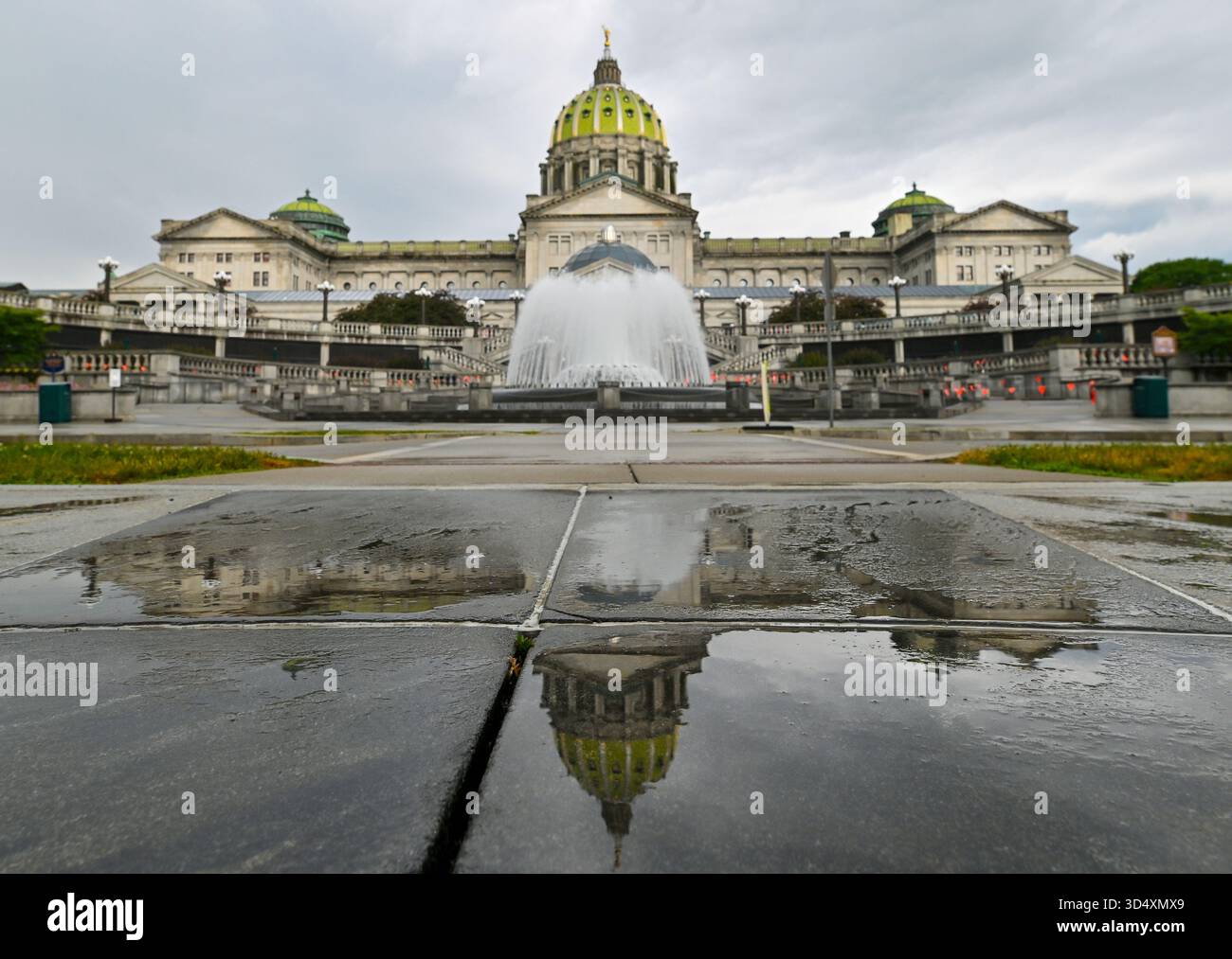 FILE - The Pennsylvania State Capitol is reflected on the ground June ...
