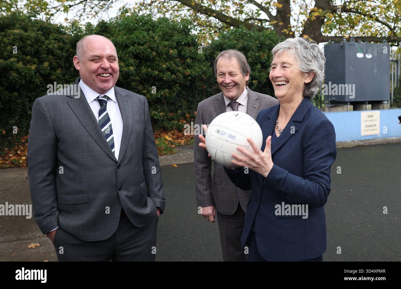 President Catherine Connolly catches a football during a visit to ...