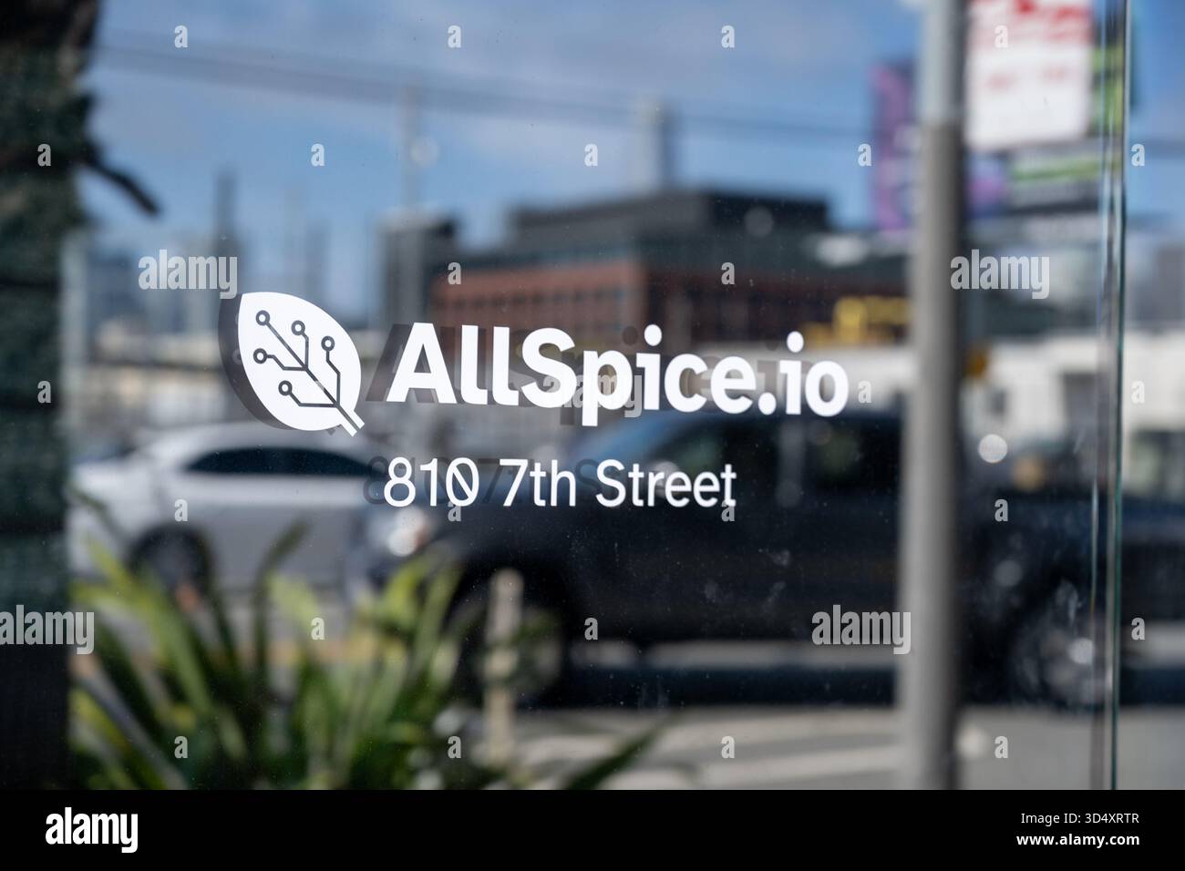 Close-up of AllSpice.io logo and 810 7th Street address on glass door ...