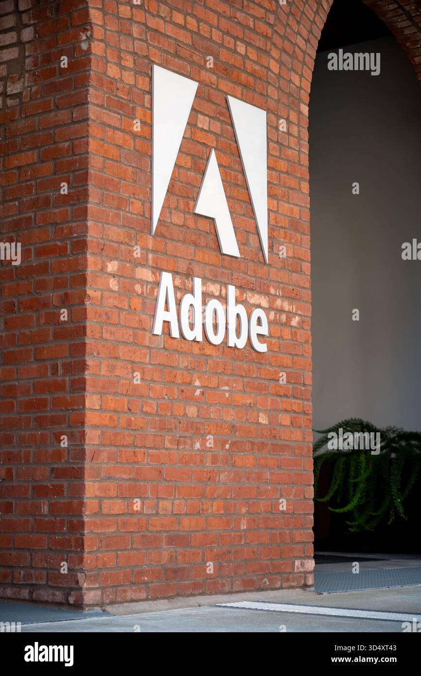 Adobe logo and sign mounted on red brick pillar at office entrance, San ...