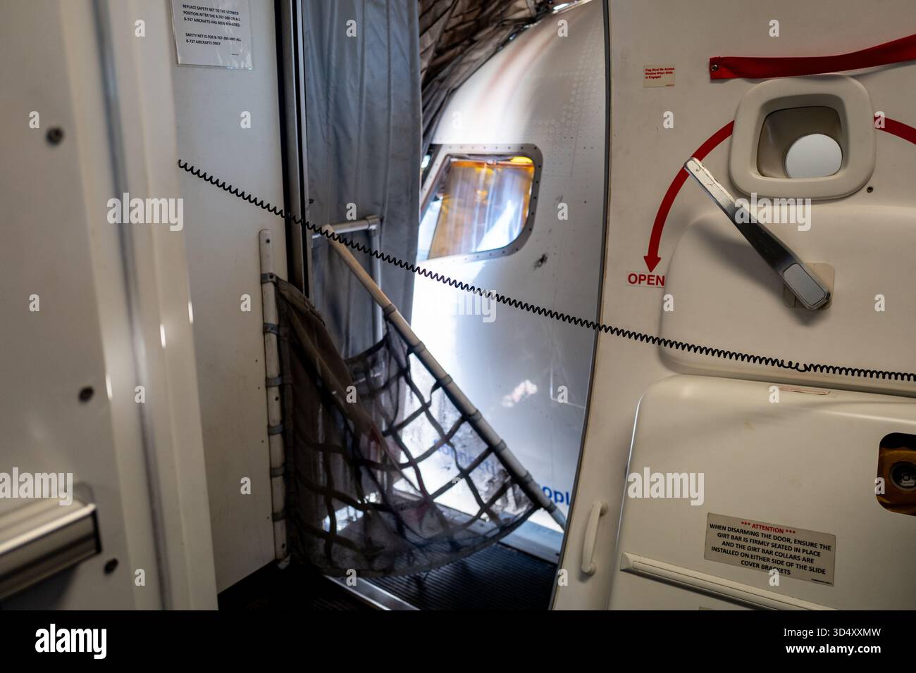 Jet bridge connected to an aircraft, with exit door and front windows ...