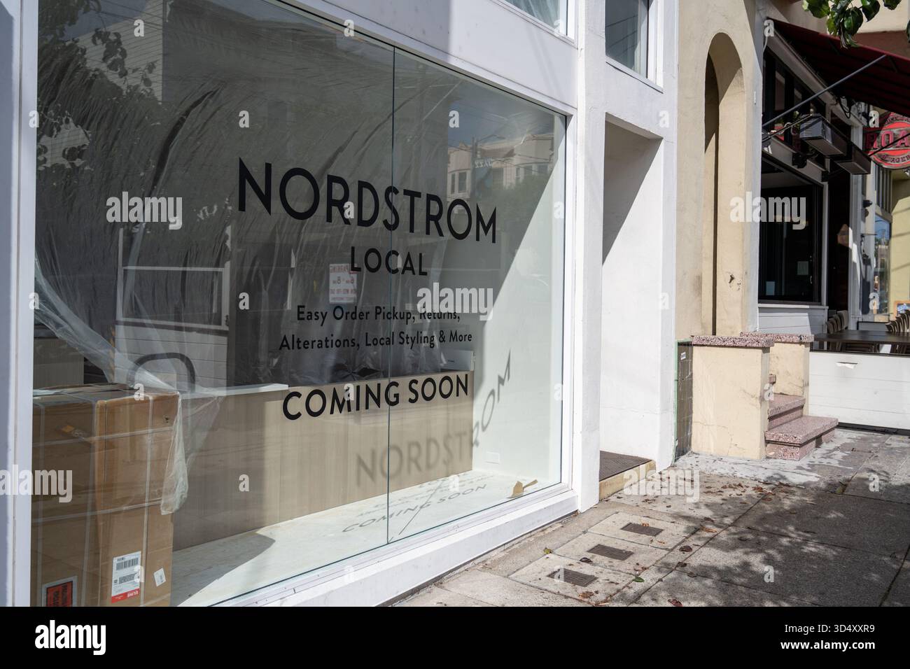 Storefront window with Nordstrom Local "Coming Soon" signage and ...