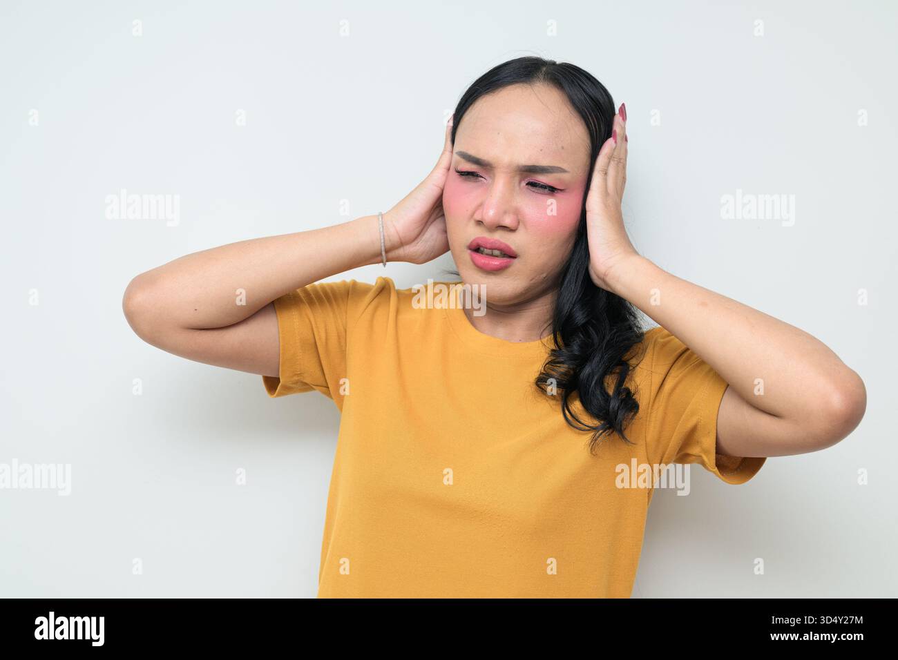 Studio portrait of a young Thai transgender individual with makeup and ...