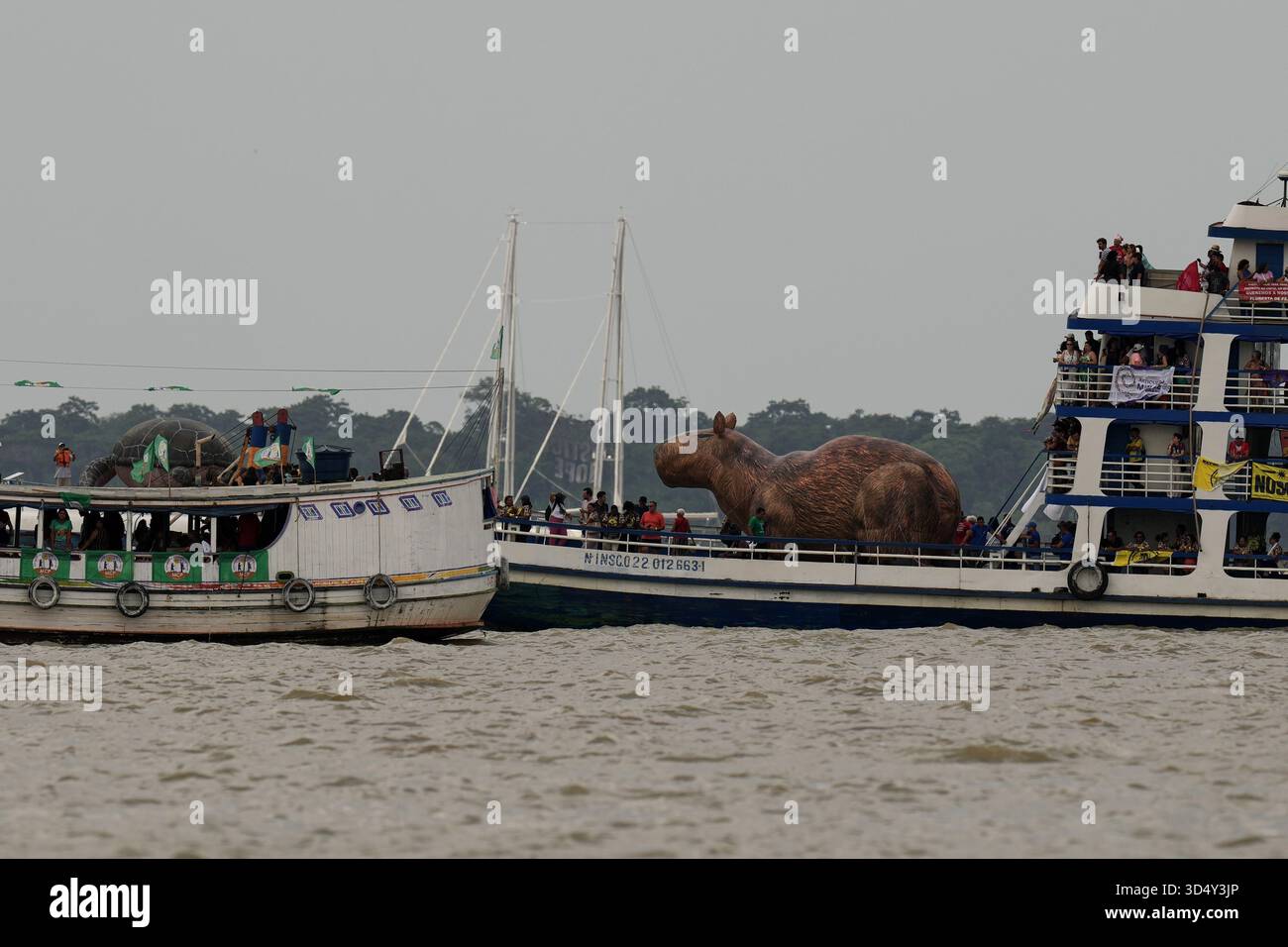 An inflatable capybara is visible on a boat participating in a People's ...