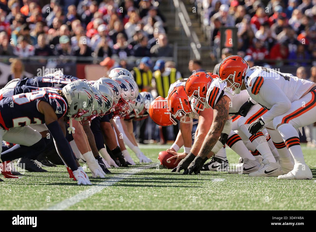 The Cleveland Browns and the New England Patriots line up at the line ...