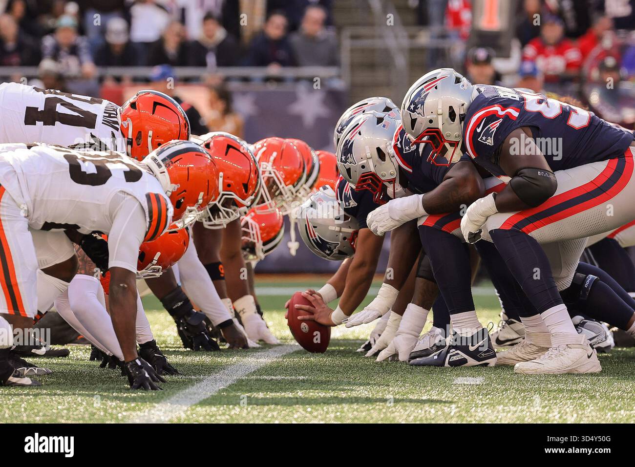 The Cleveland Browns and the New England Patriots line up at the line ...