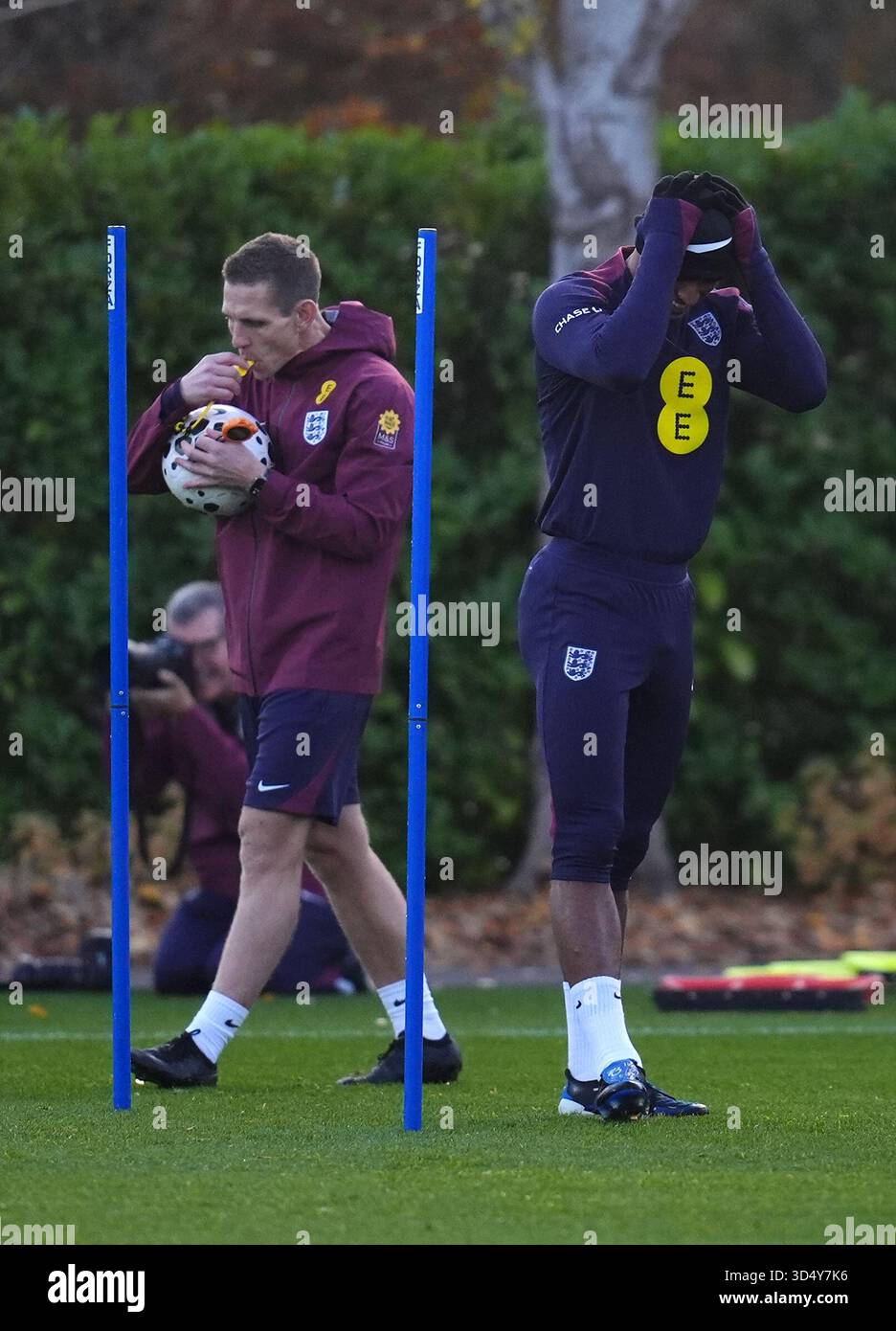 England's Jude Bellingham (right) reacts during a training session at ...