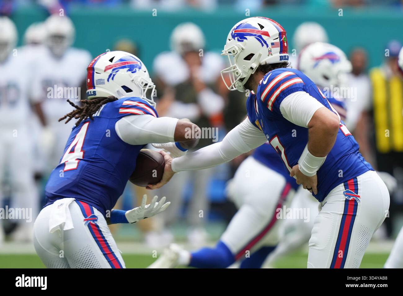 Buffalo Bills quarterback Josh Allen, right, hands off the football to ...