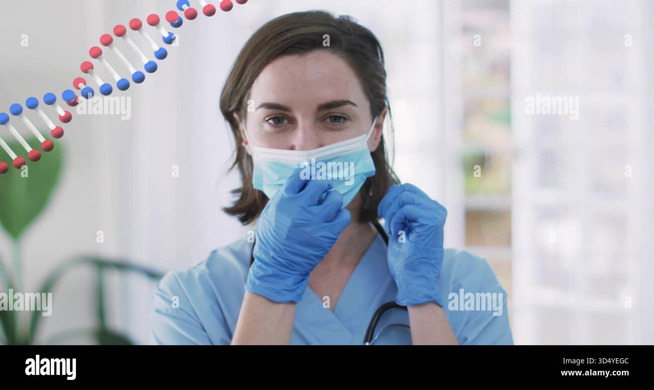 Adjusting clinician securing surgical mask in clinic wearing scrubs ...