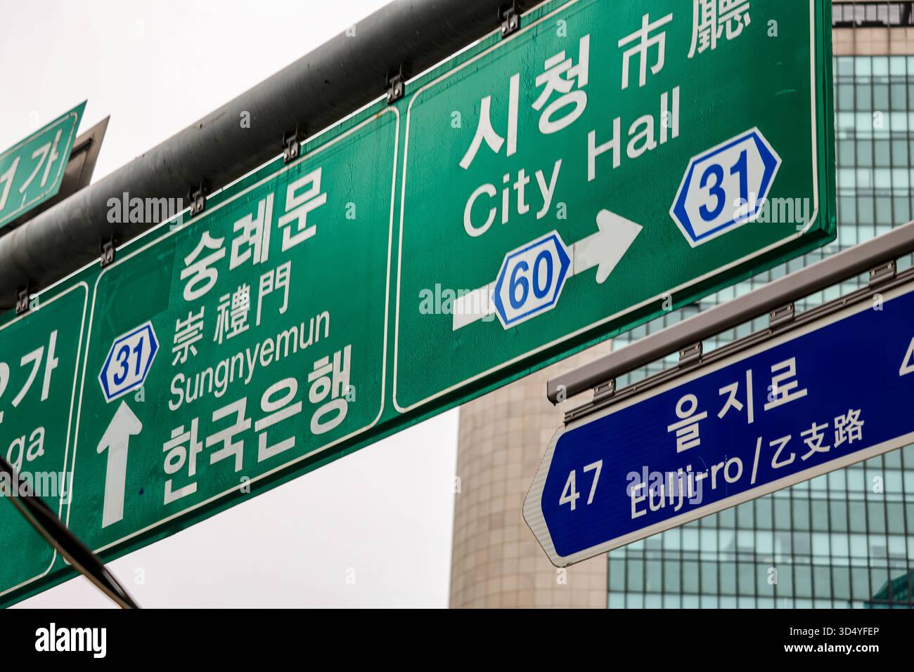 Green and blue street signs providing directions and road numbers in ...