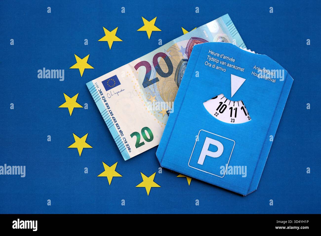 European parking disc with time dial and 20 euro money bill banknote on ...