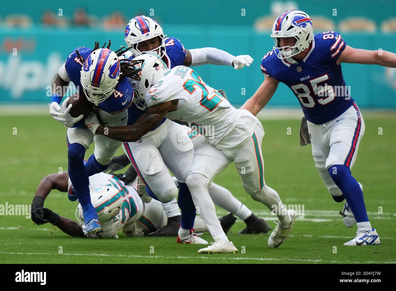 Buffalo Bills running back James Cook, left, is tackled by Miami ...