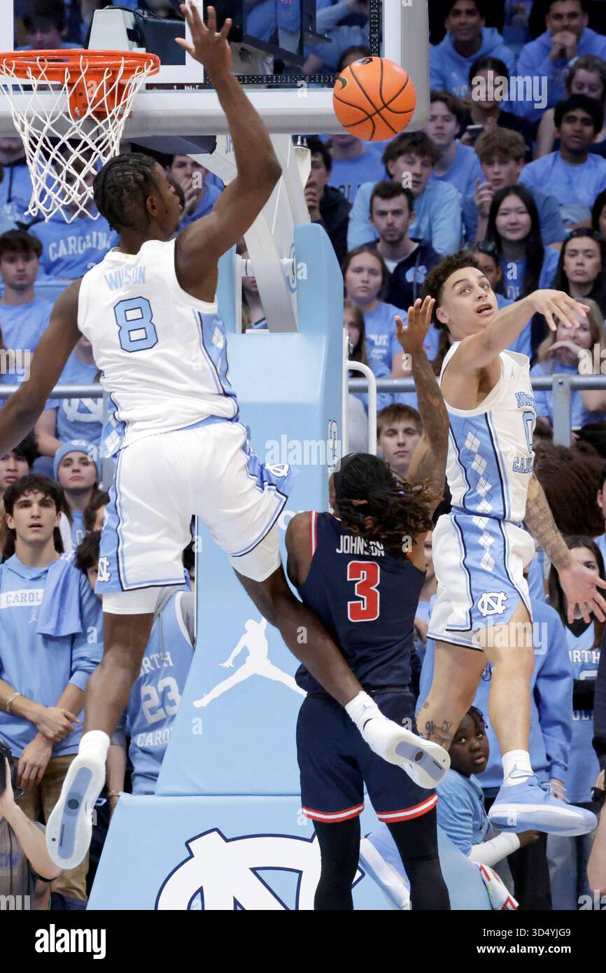 North Carolina forward Caleb Wilson (8) and guard Kyan Evans (0) defend ...