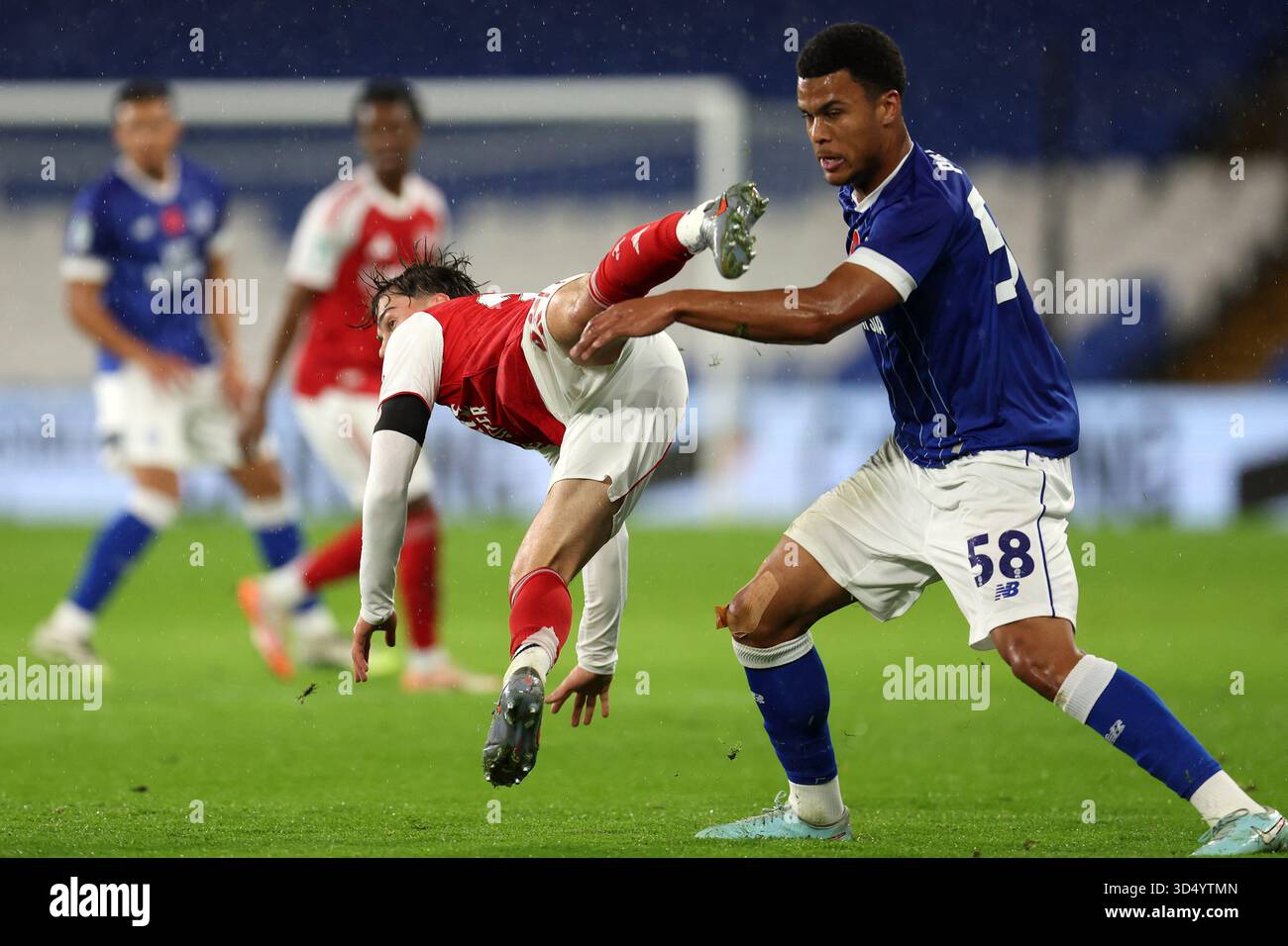 Harrison Dudziak of Arsenal U21 is tackled by Jay Parfitt of Cardiff ...