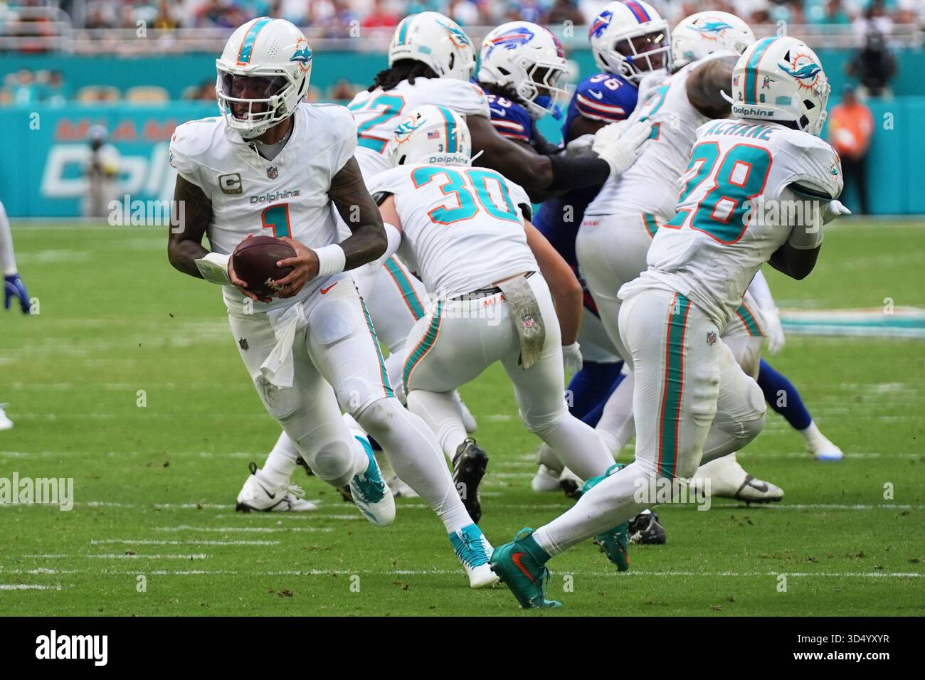 Miami Dolphins quarterback Tua Tagovailoa (1) moves from the pocket ...