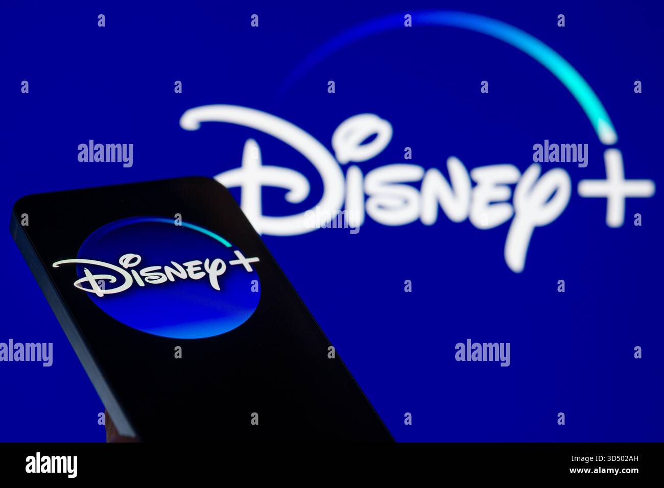The Disney Plus logo is displayed on a mobile phone with the company ...