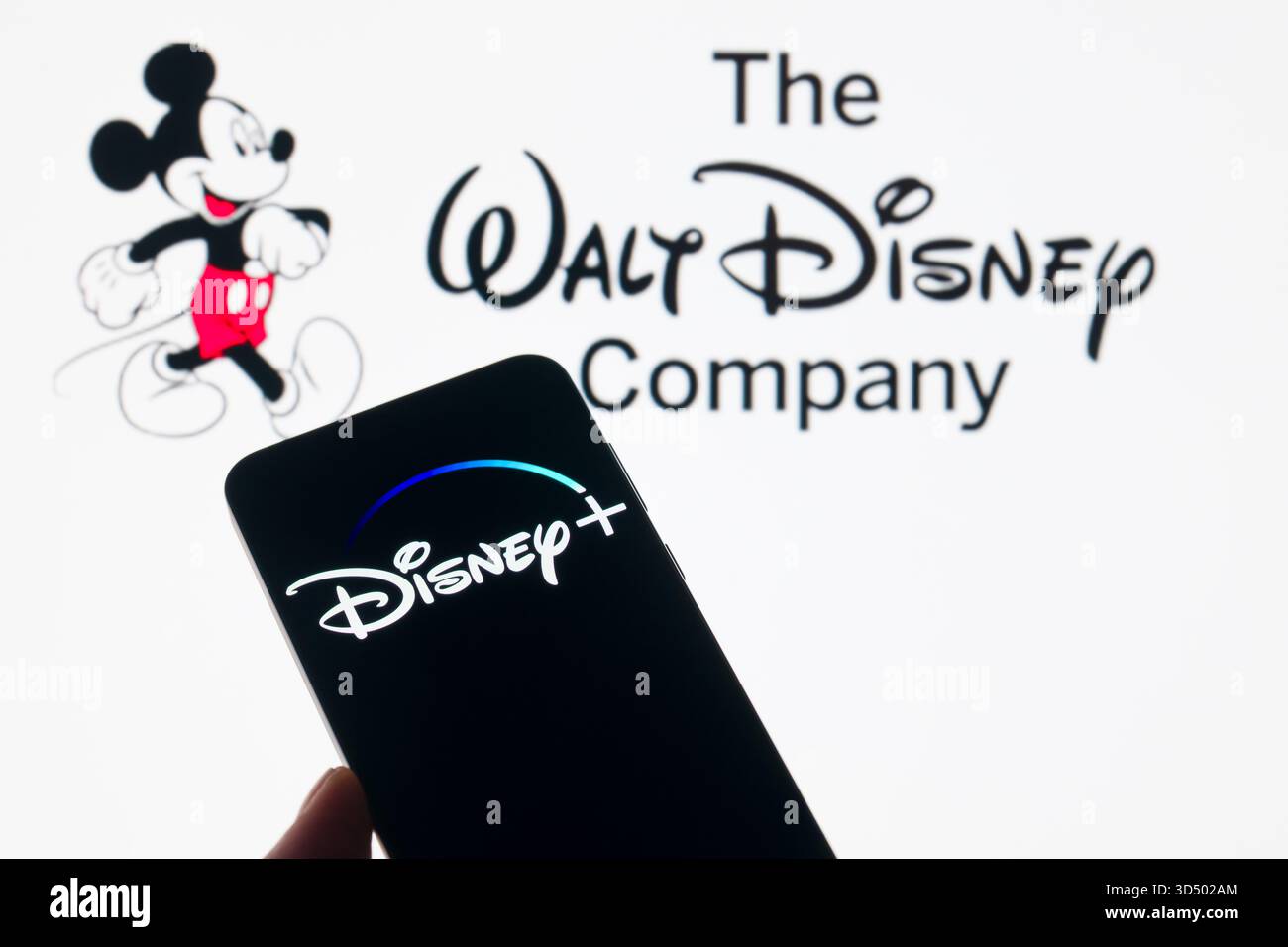 The Disney Plus logo is displayed on a mobile phone with the company ...