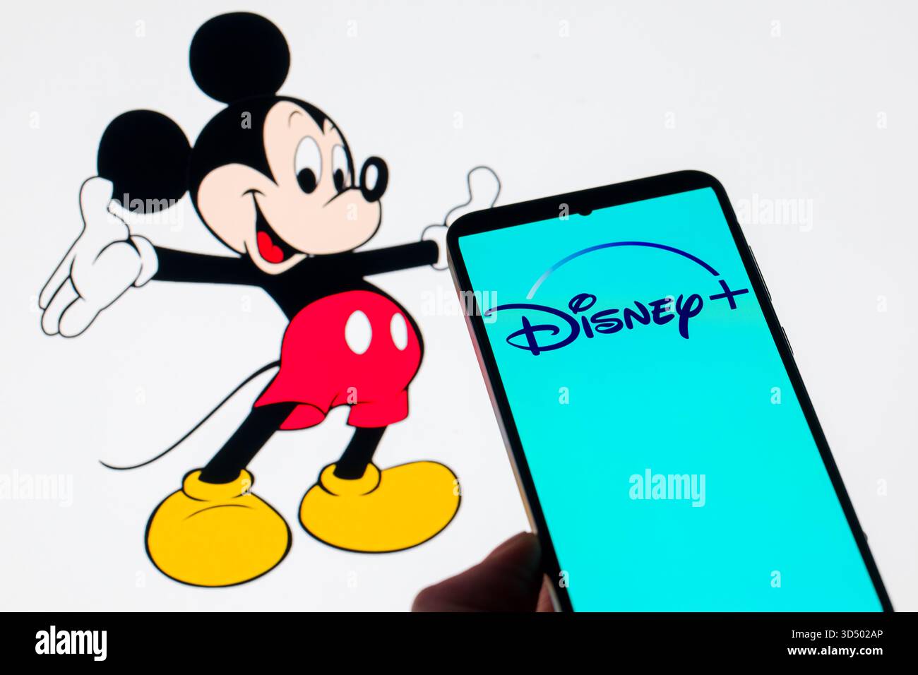 The Disney Plus logo is displayed on a mobile phone with The Walt ...