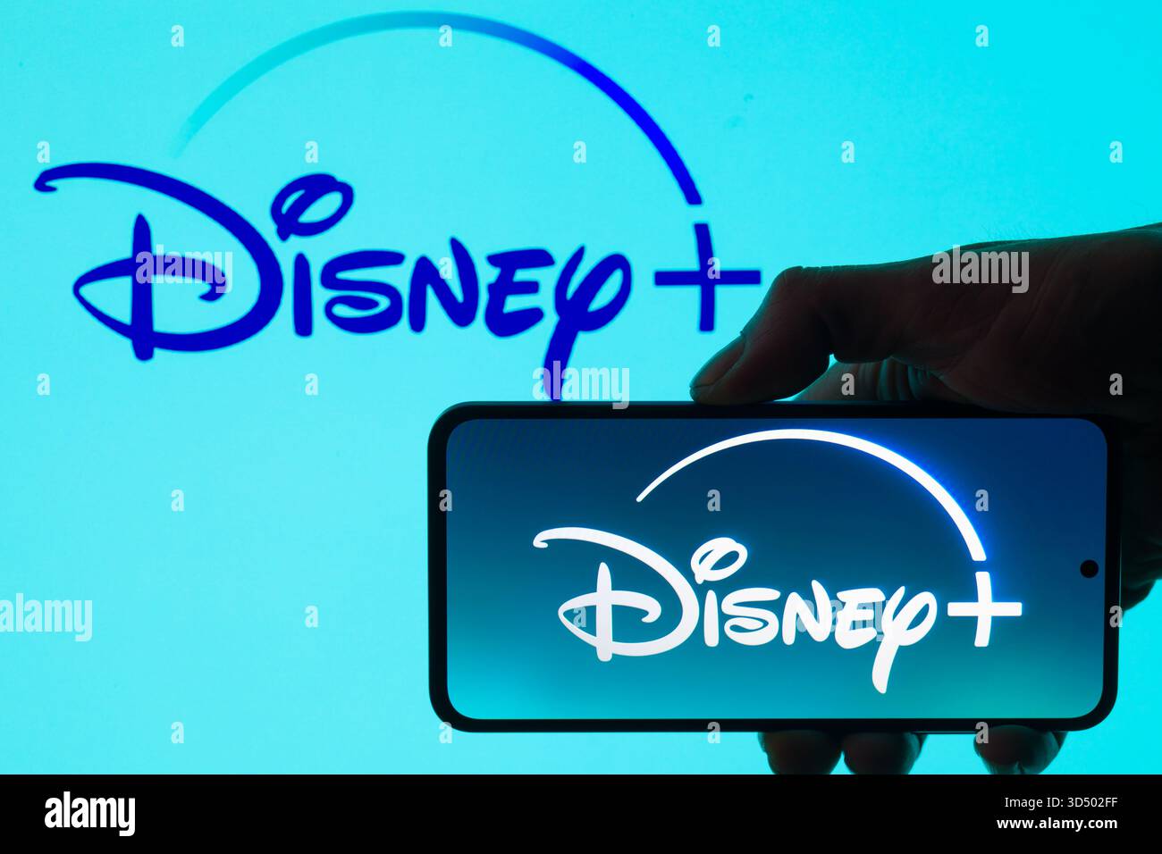The Disney Plus logo is displayed on a mobile phone with the company ...