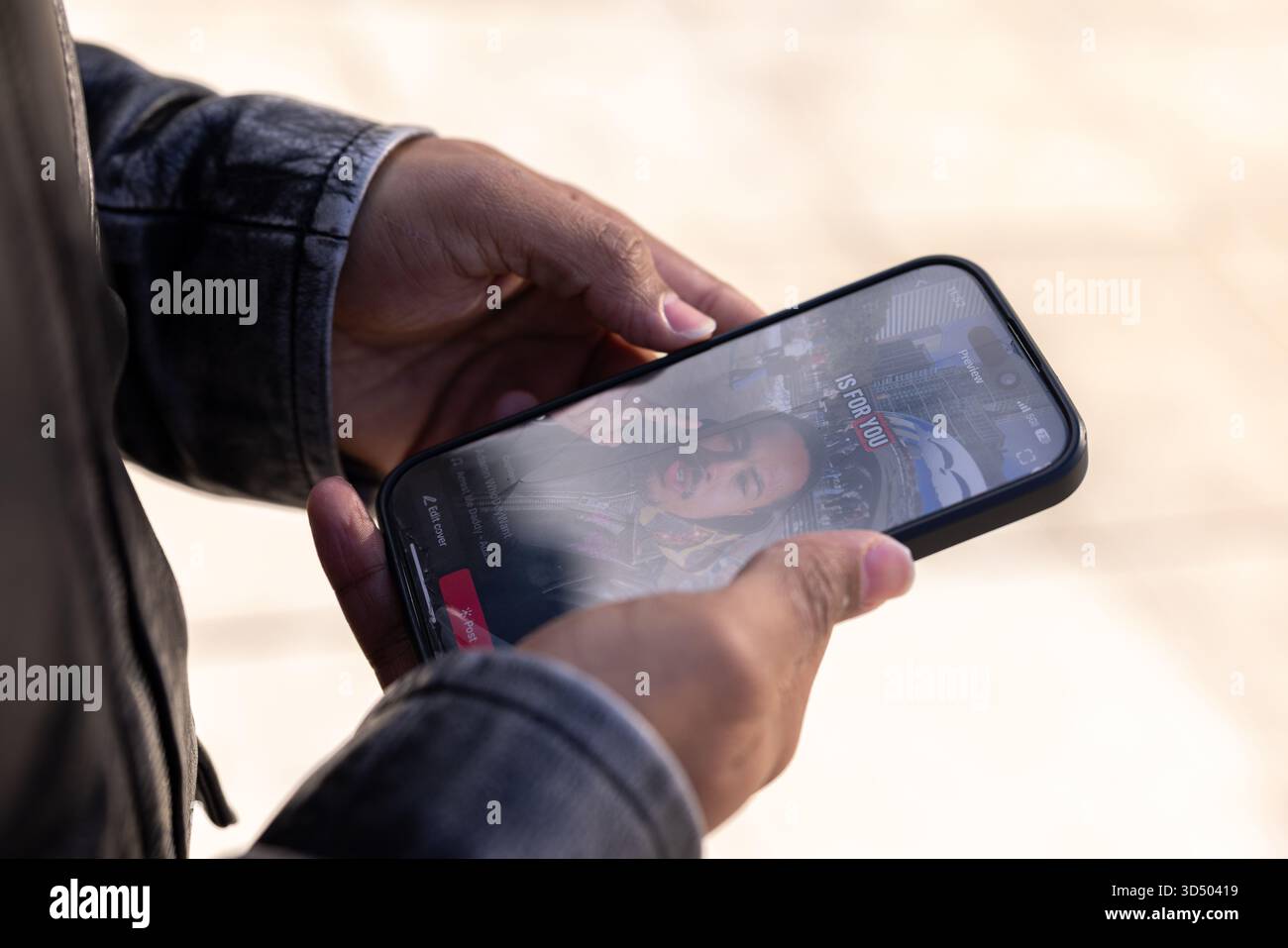 Chicago rapper Adamn Killa edits a TikTok video he just filmed in front ...