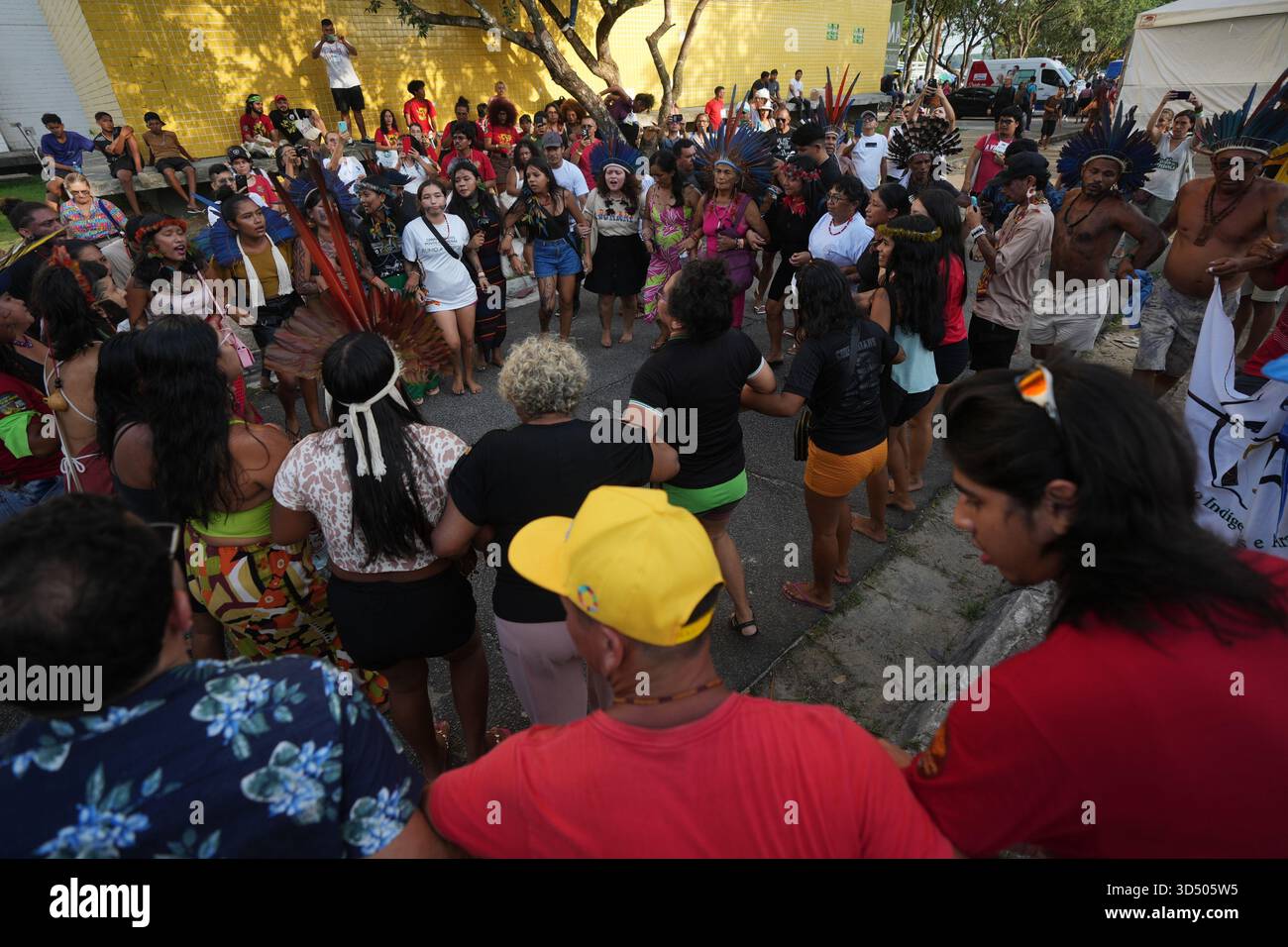 Indigenous peoples sing and dance as they participate in an opening ...
