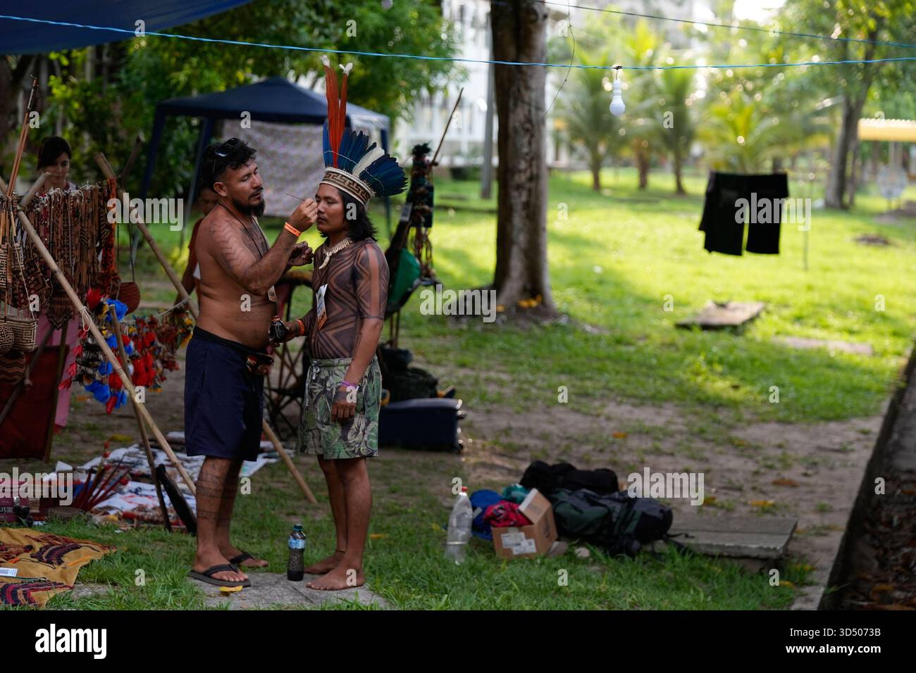 An Indigenous participant gets their face painted at the opening ...