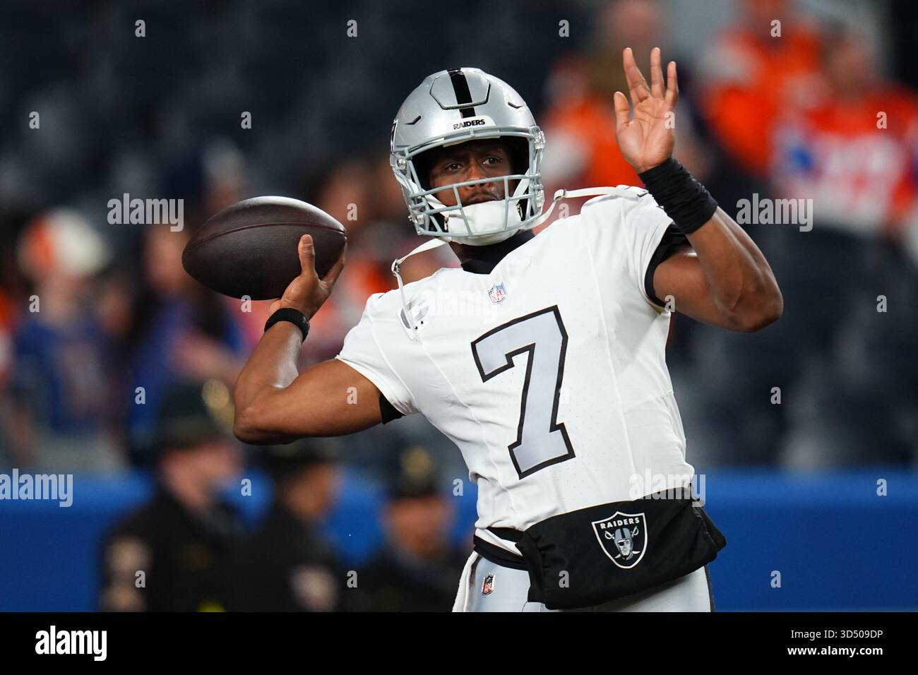 Las Vegas Raiders quarterback Geno Smith warms up against the Denver ...