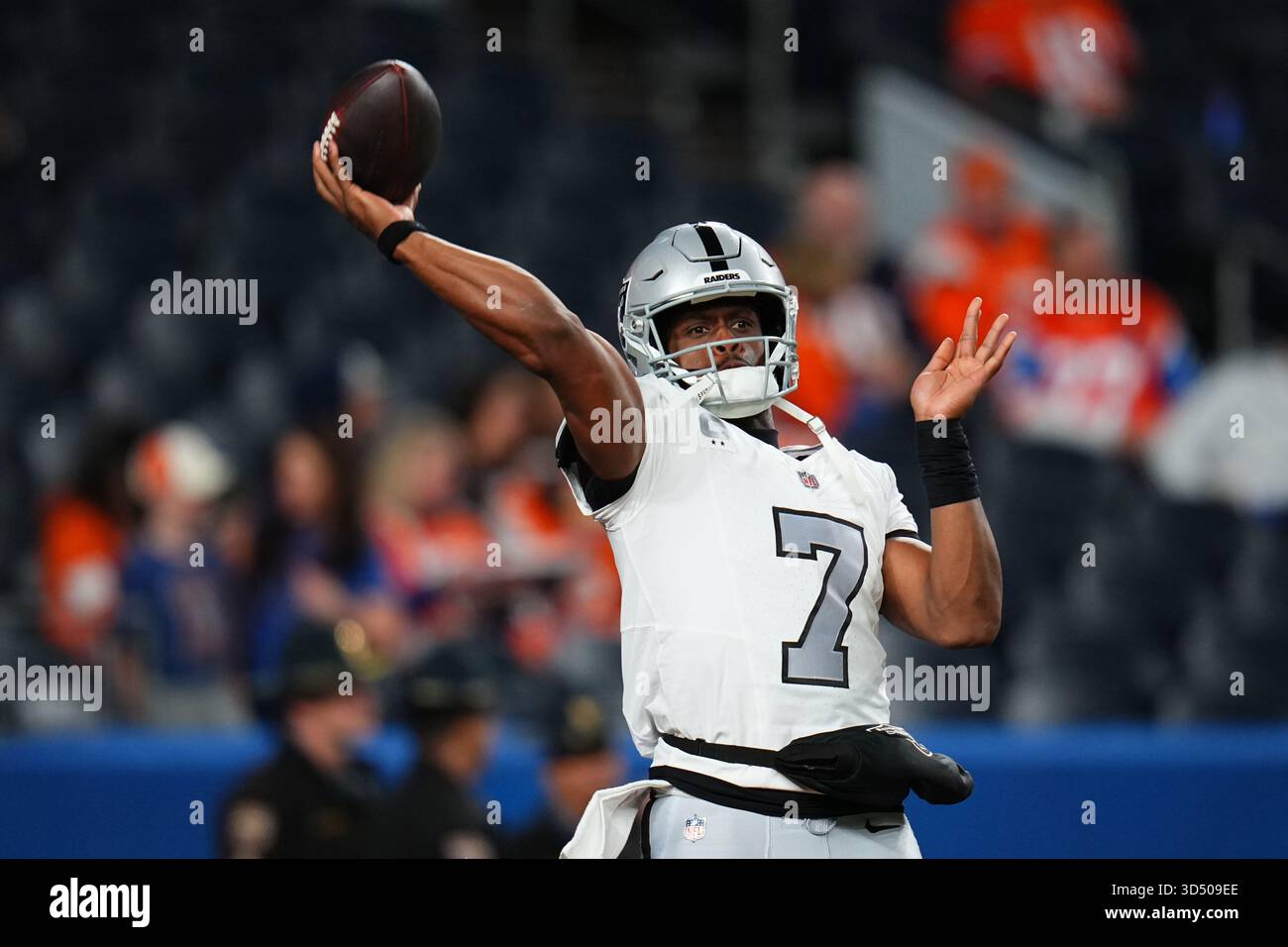 Las Vegas Raiders quarterback Geno Smith warms up against the Denver ...