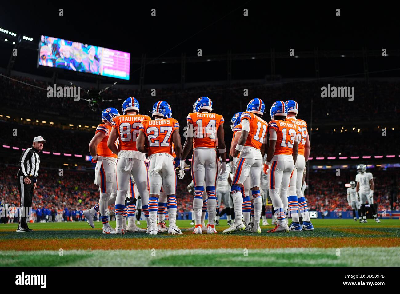 Members of the Denver Broncos huddle against the Las Vegas Raiders ...
