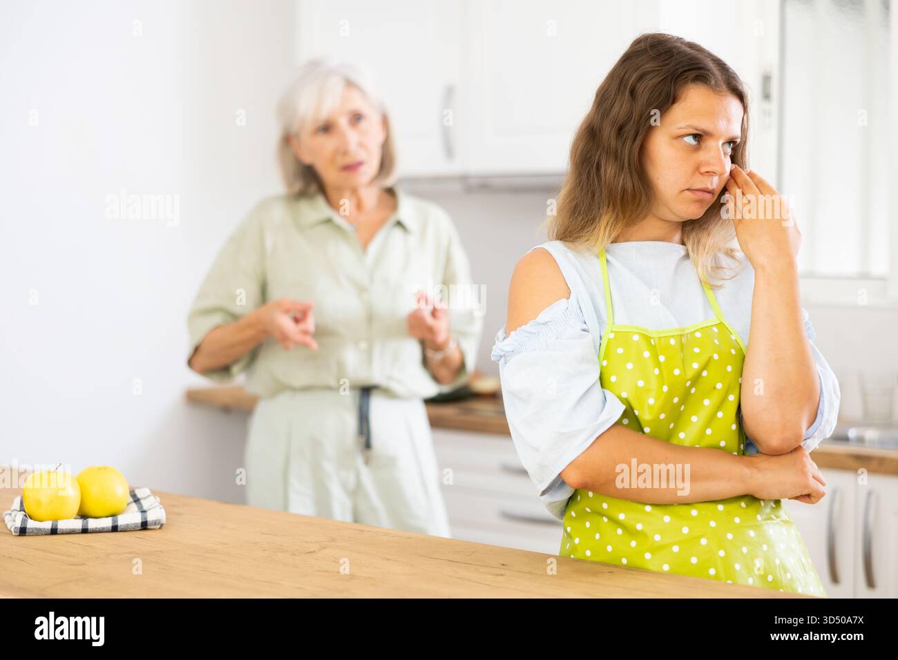 Sad woman ignoring her senior mother arguing with her Stock Photo - Alamy