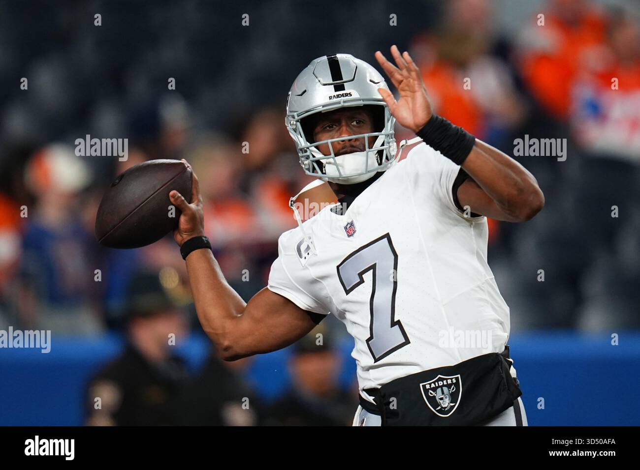 Las Vegas Raiders quarterback Geno Smith warms up against the Denver ...