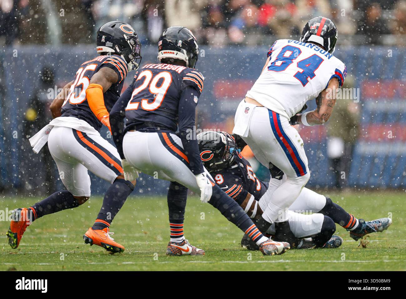 Chicago Bears safety Jaquan Brisker (9) tackles New York Giants tight ...