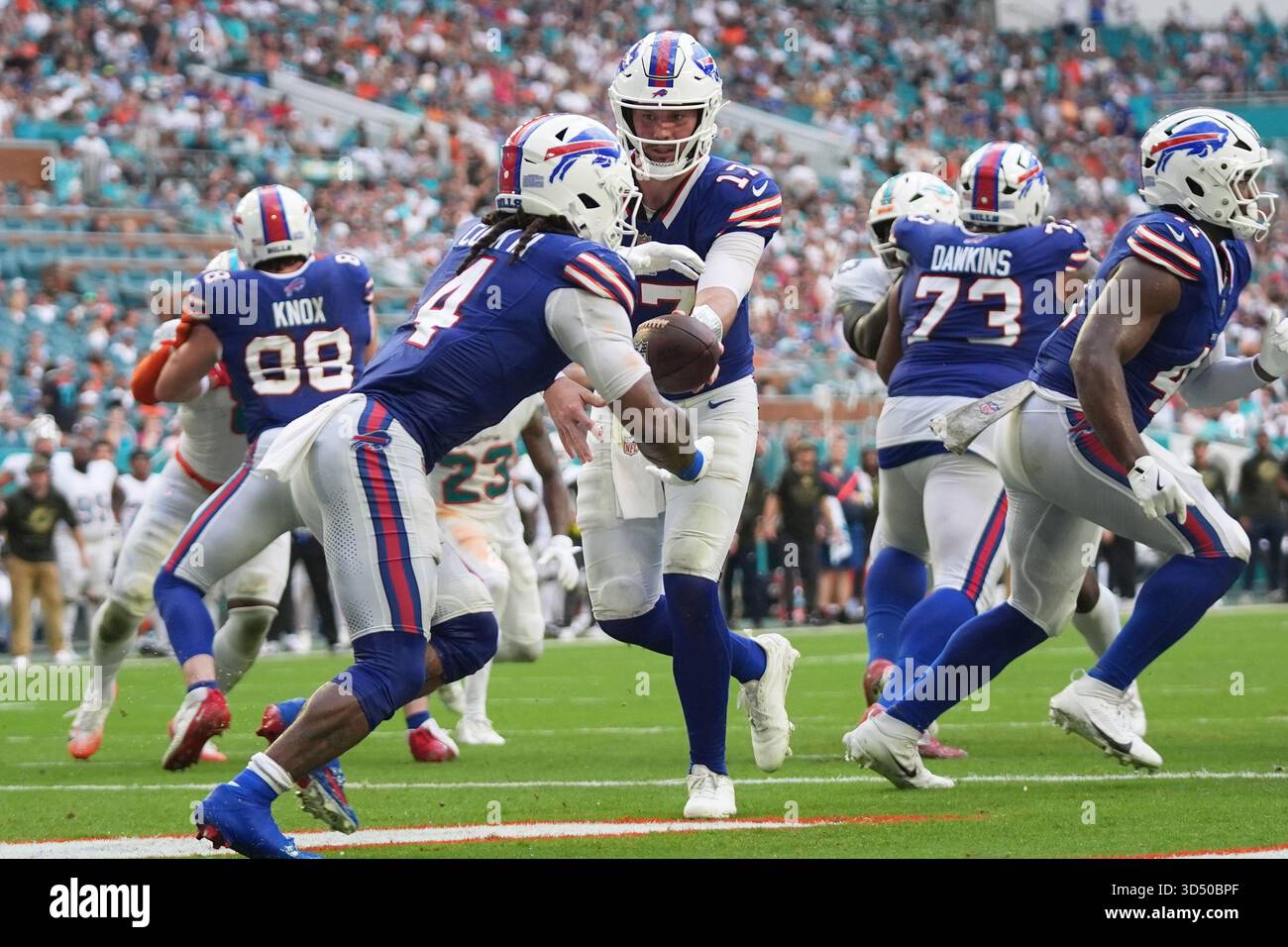 Buffalo Bills quarterback Josh Allen, center, hands off the football to ...