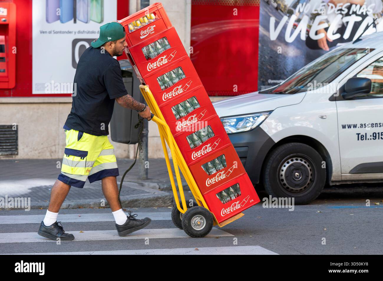 A delivery worker carries goods from the American soft drink brand Coca ...