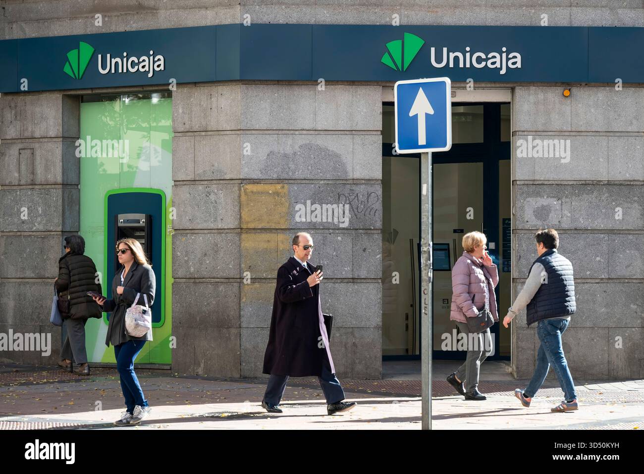 Pedestrians walk past the Spanish savings bank Unicaja bank branch in ...