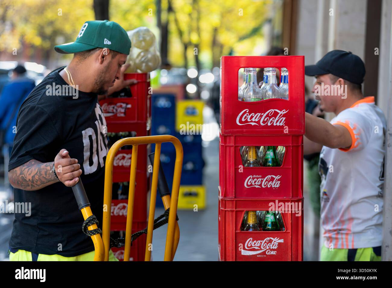 A delivery worker carries goods from the American soft drink brand Coca ...