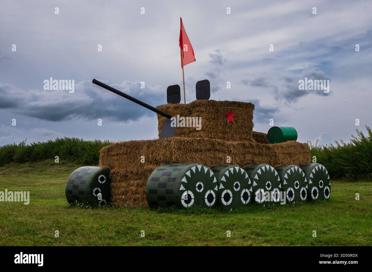 The straw tank is made from bales of mown hay bearing a star and a red ...