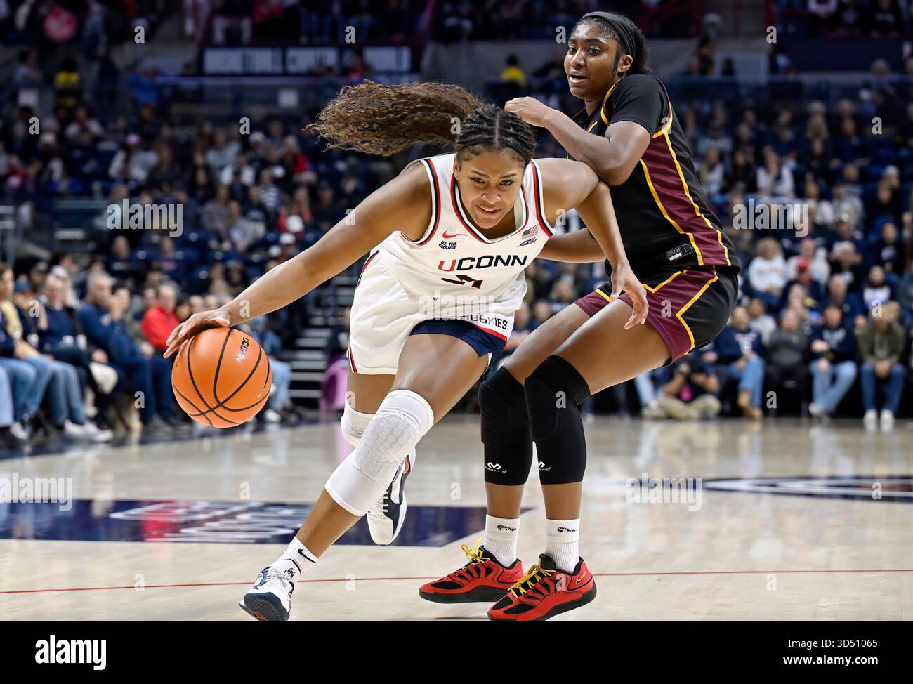 UConn forward Sarah Strong drives to the basket as Loyola Chicago guard ...