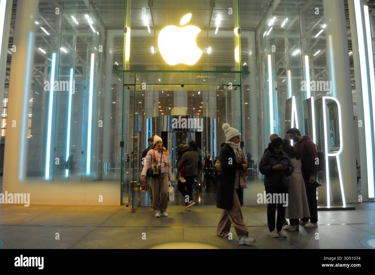 People exit an Apple store on Fifth Avenue in Manhattan, New York City ...