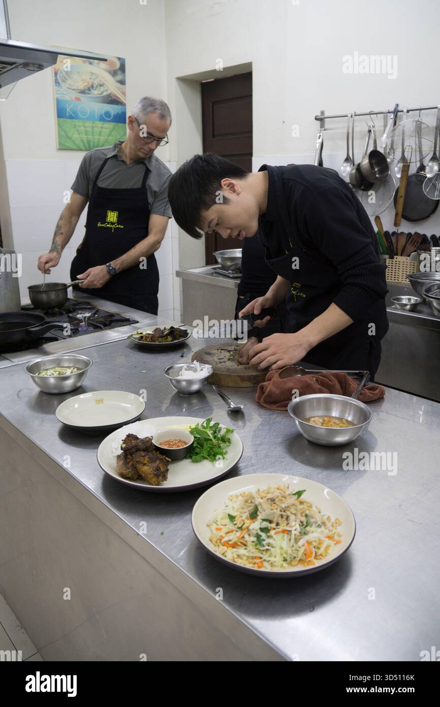 Chef instructing man how to cook Vietnamese food Hanoi, Vietnam Stock ...