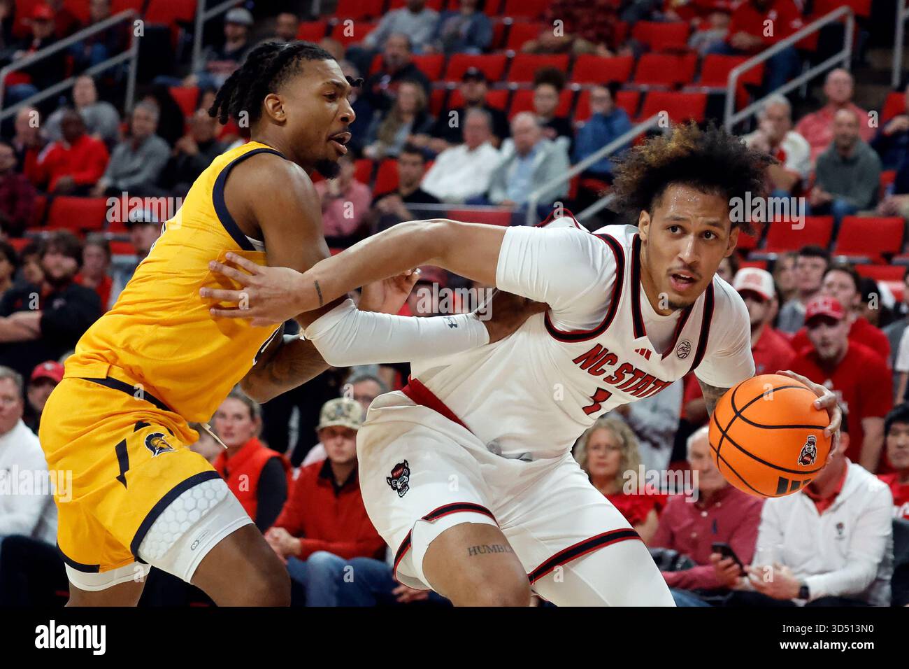 North Carolina State's Darrion Williams (1) drives the ball around UNC ...