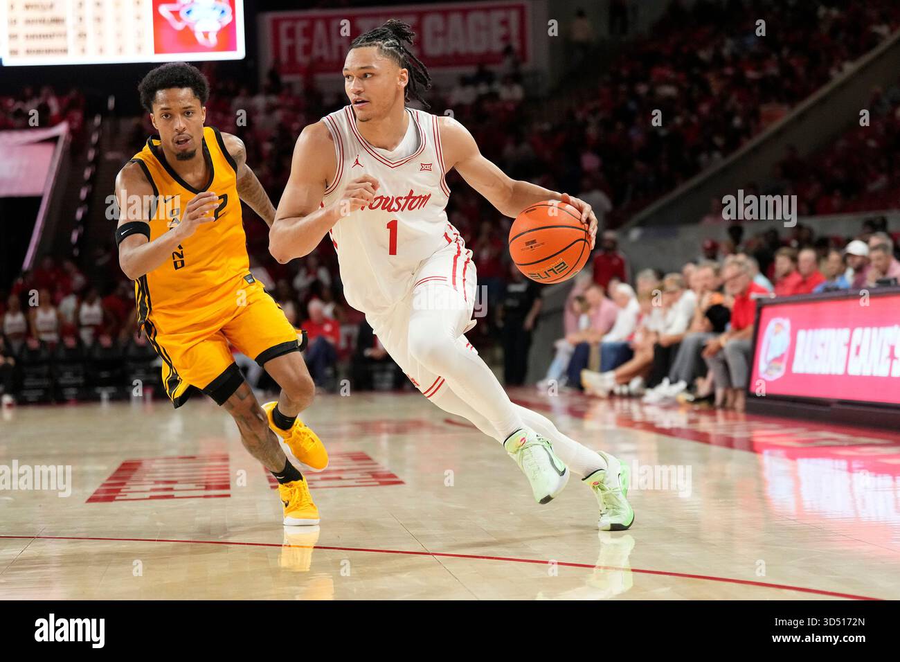 Houston guard Isiah Harwell (1) runs the ball against Oakland guard ...