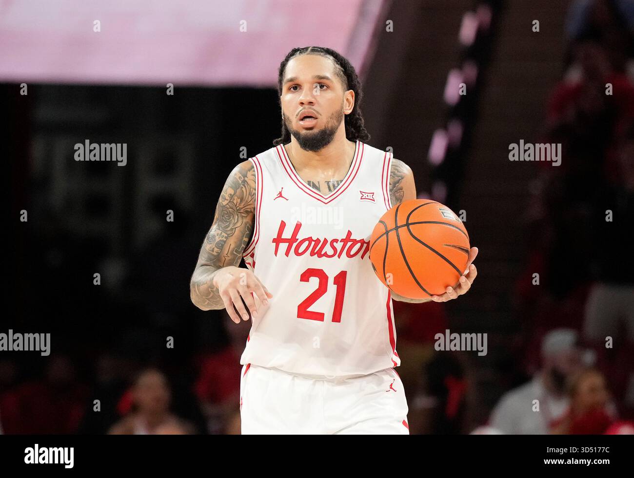 Houston guard Emanuel Sharp (21) runs up the court against Oakland ...
