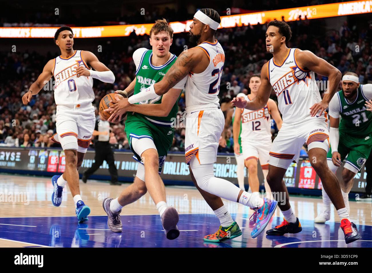 Dallas Mavericks' Cooper Flagg (32) drives to the basket as Phoenix ...