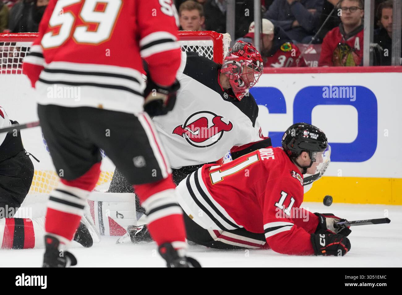 New Jersey Devils goaltender Jacob Markstrom, back center, makes a save ...