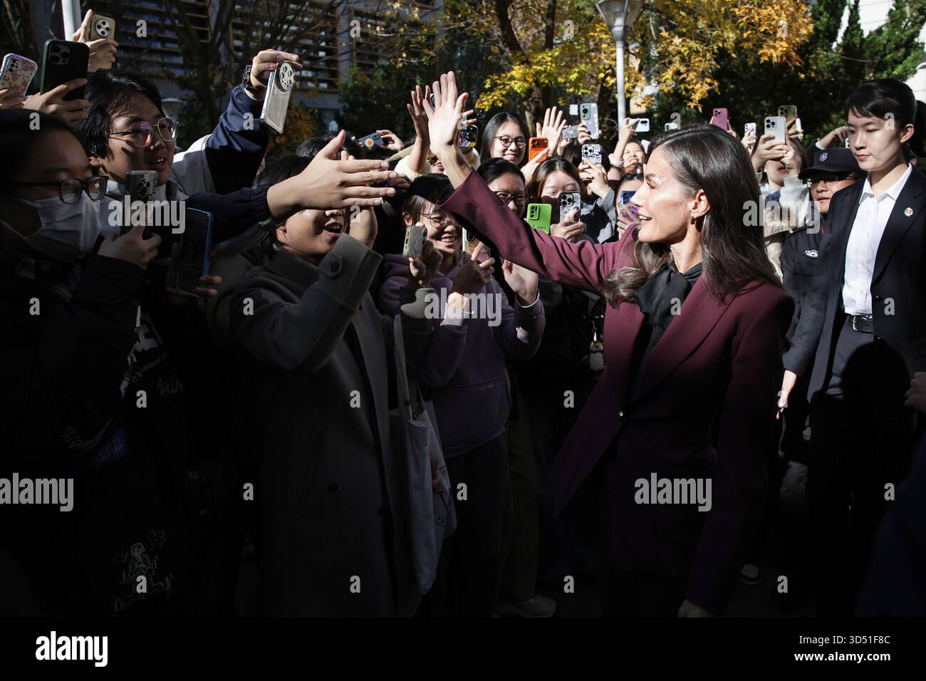 Spain's Queen Letizia, foreground right, greets students at the Beijing ...