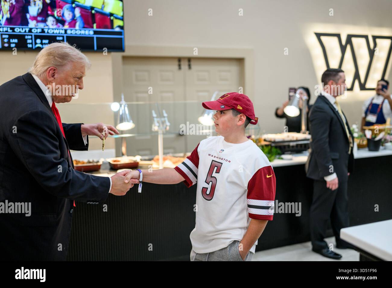President Donald Trump presents a Presidential Challenge Coin to a ...